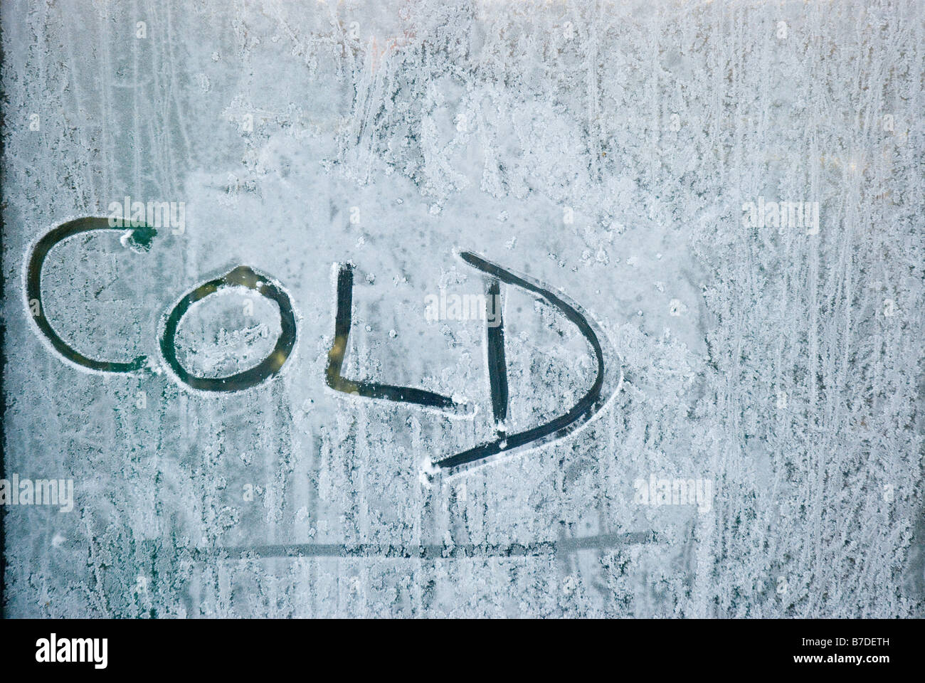 COLD written of frost covered window Stock Photo - Alamy
