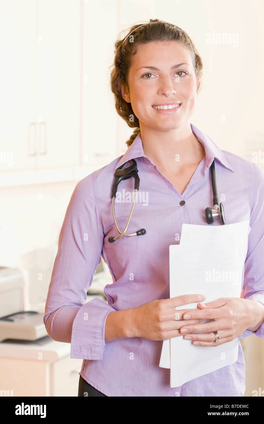 A female doctor holding some notes Stock Photo - Alamy
