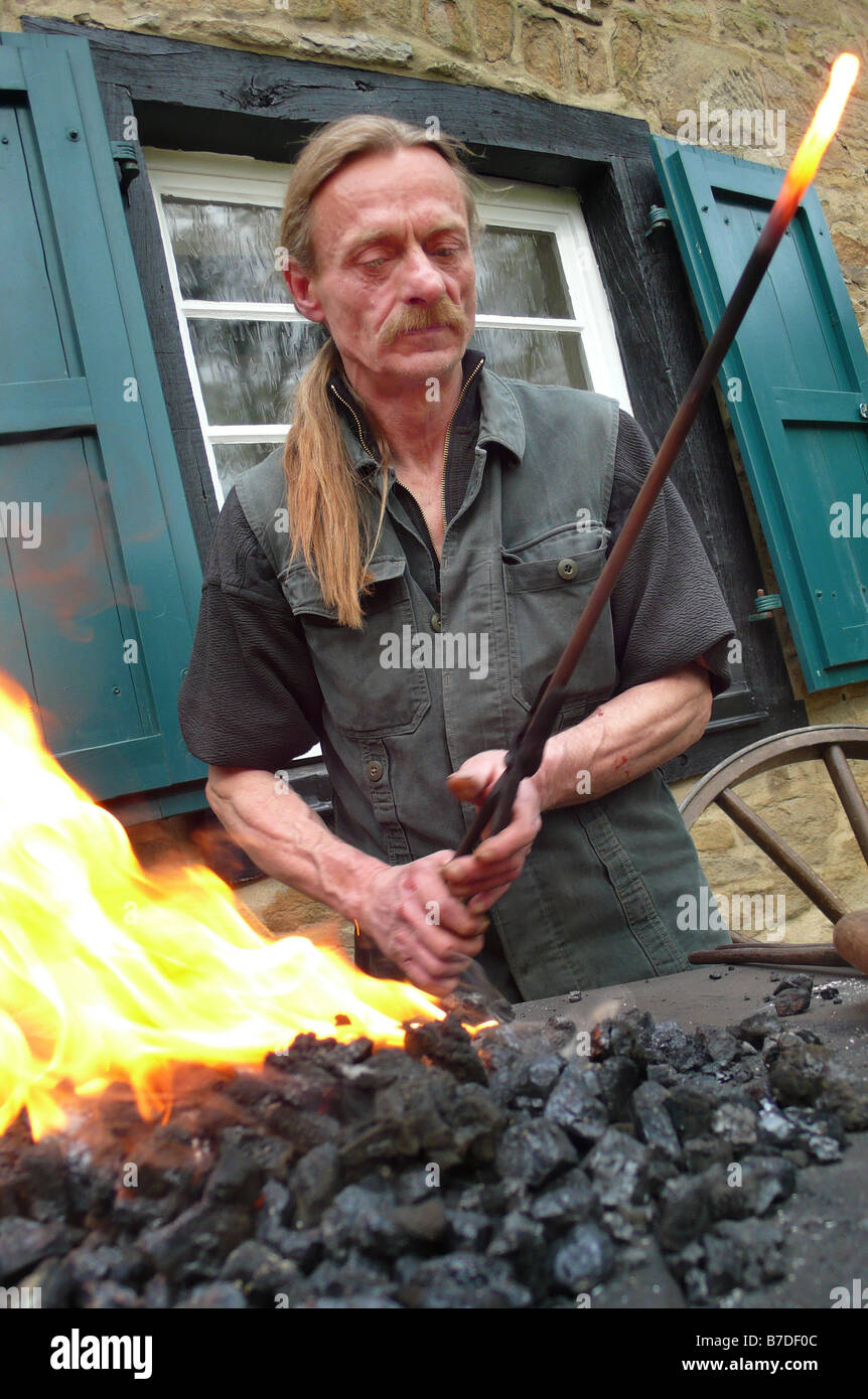 One smith blacksmith man forging hi-res stock photography and images ...