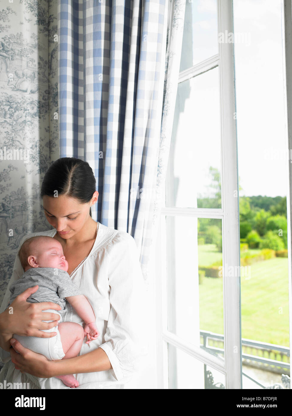 Mother and baby by the window Stock Photo - Alamy