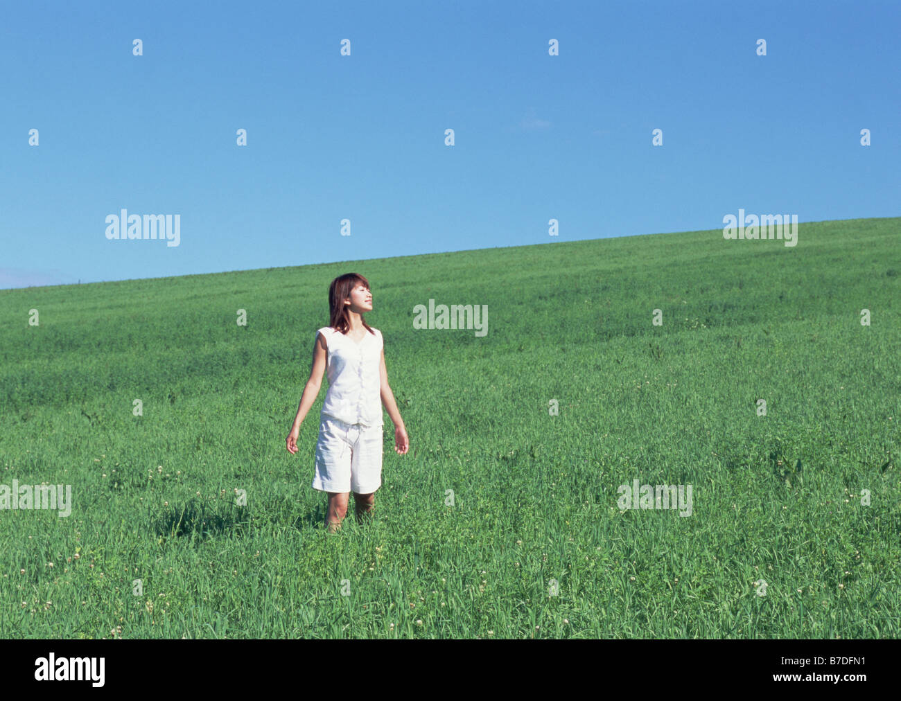 Woman standing in field Stock Photo - Alamy