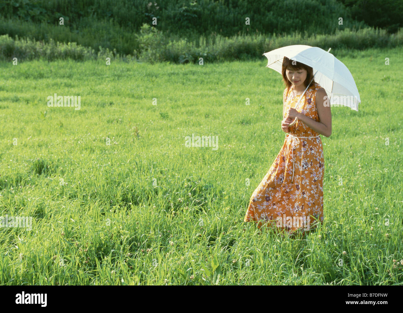Woman standing in field Stock Photo - Alamy