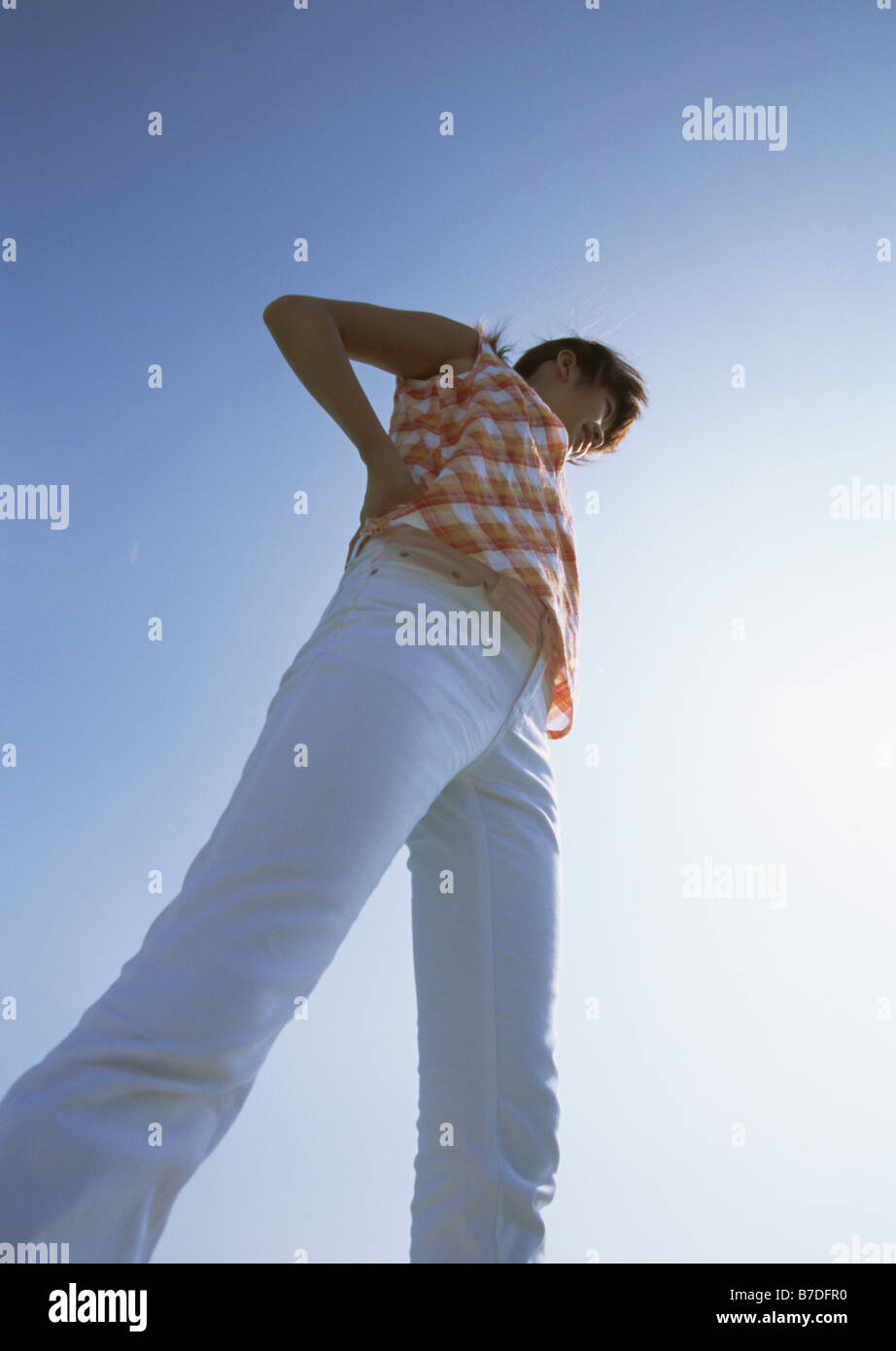 Woman standing under the sun Stock Photo - Alamy