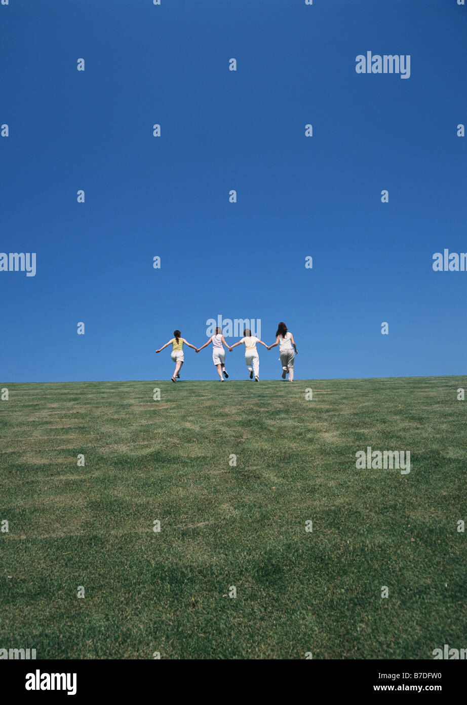 Women running in field Stock Photo - Alamy
