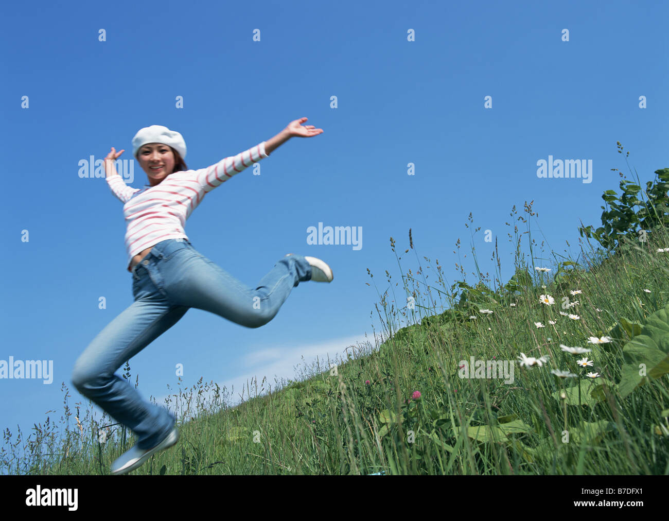 Woman jumping up in field Stock Photo - Alamy