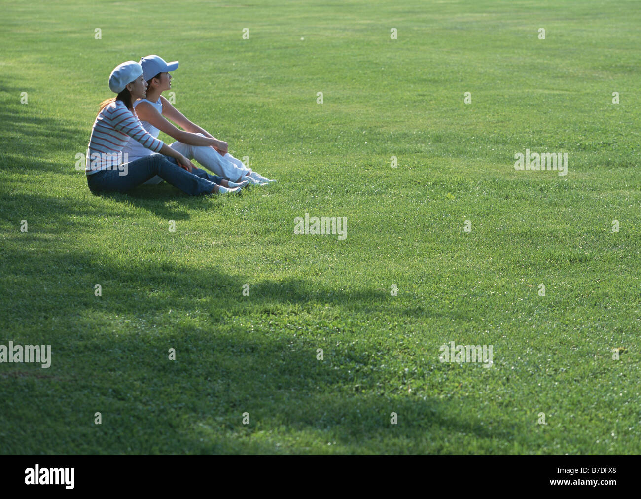 Women sitting in field Stock Photo - Alamy
