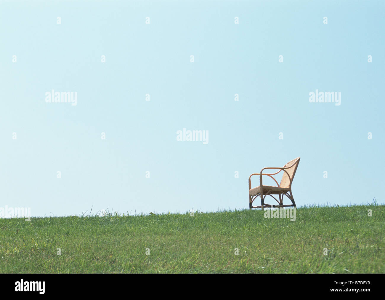 Bench in field Stock Photo - Alamy