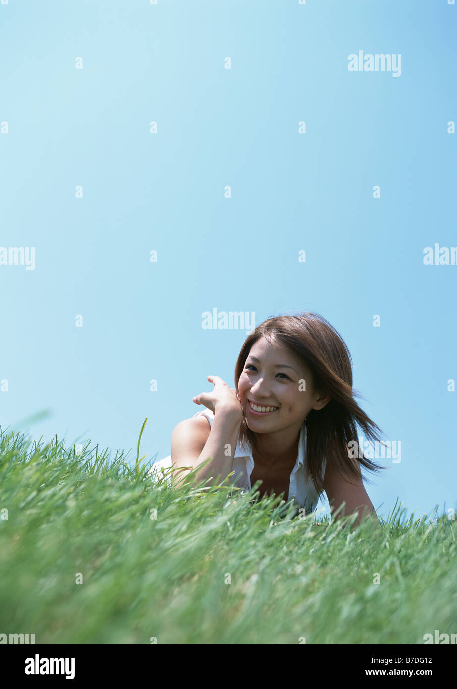 Relaxed woman smiling in field Stock Photo - Alamy