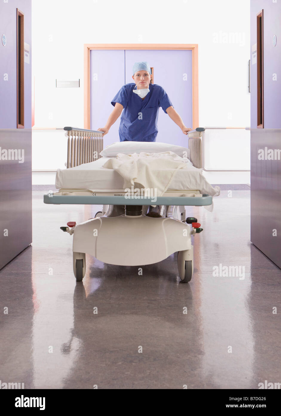 A female doctor pushing a bed Stock Photo - Alamy