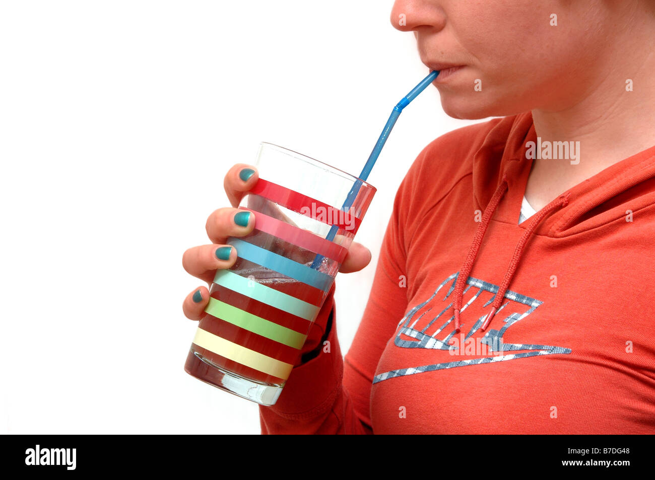 a young woman has a drink using a straw Stock Photo - Alamy