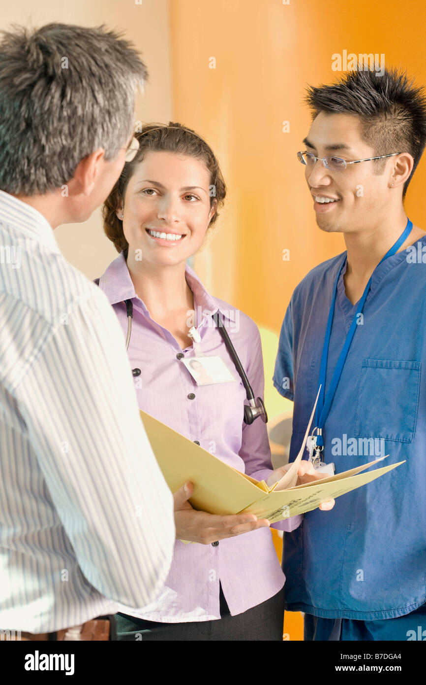 Three medical colleagues talking Stock Photo - Alamy