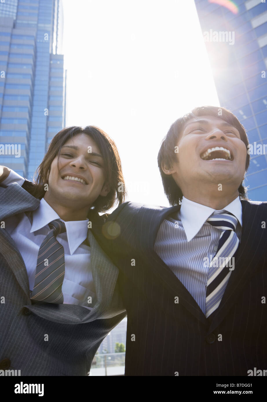 Businessmen with arms around shoulder Stock Photo - Alamy