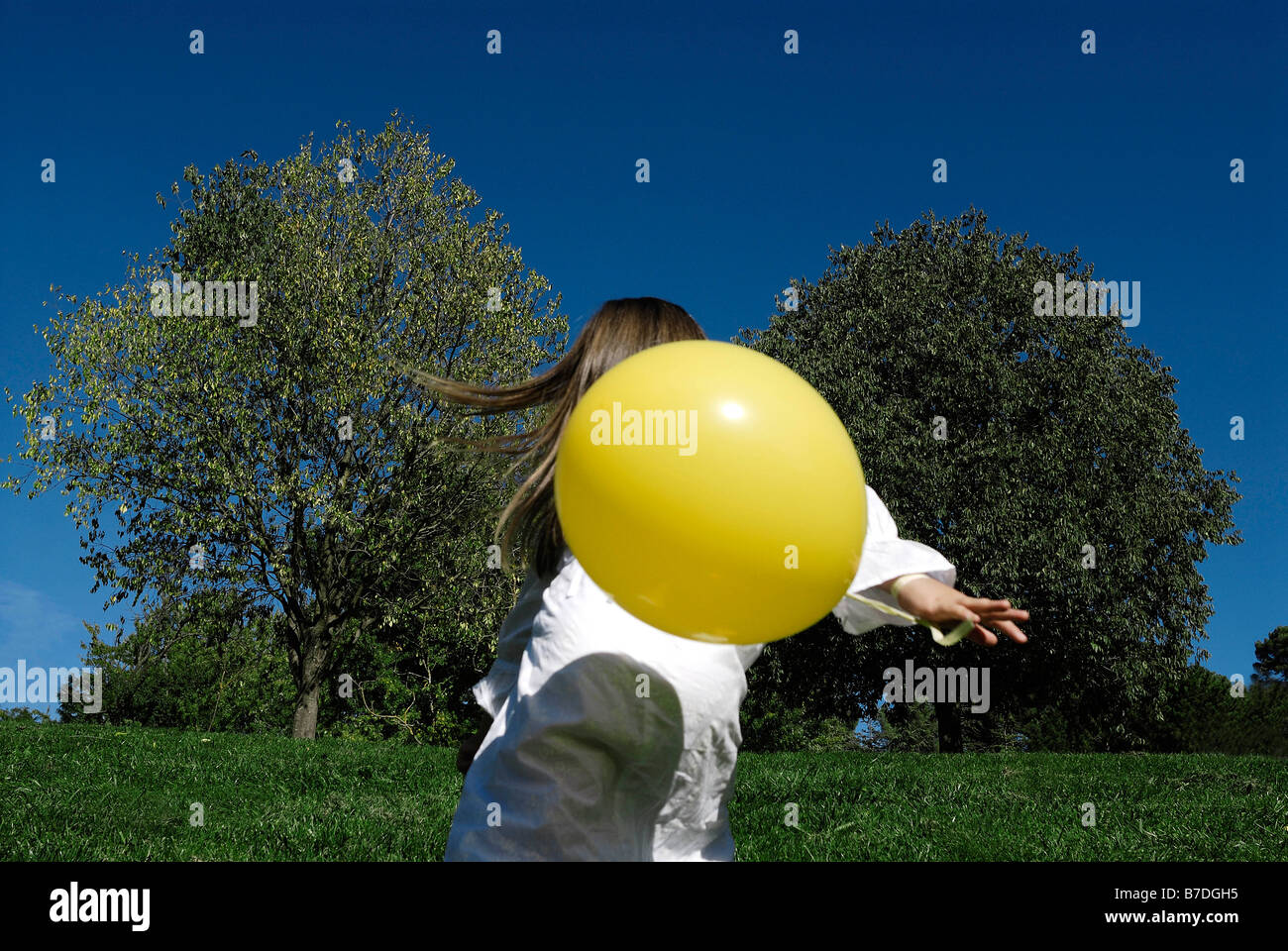 5 years old girl holding a balloon Stock Photo - Alamy