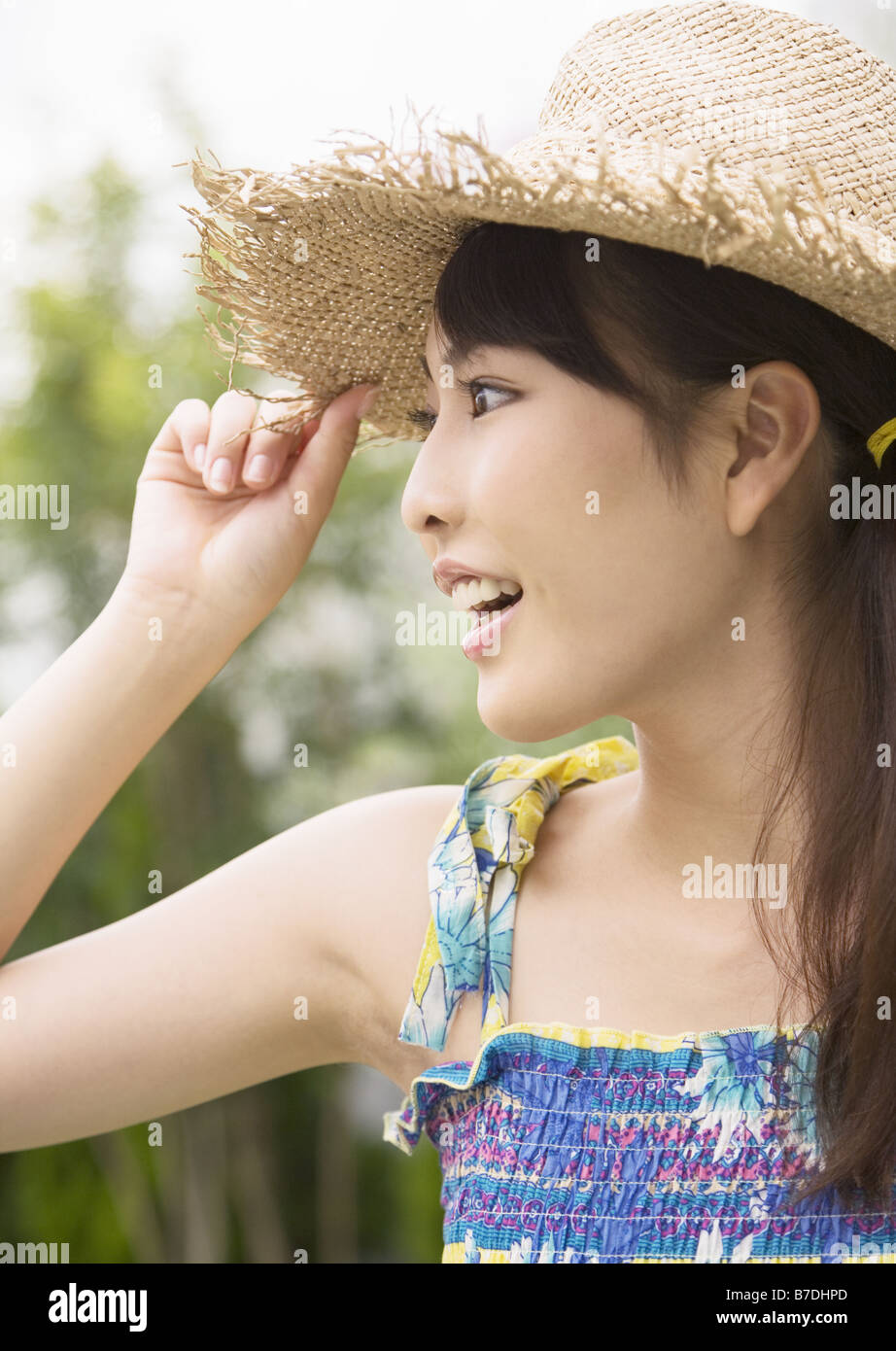 A woman wearing straw hat Stock Photo - Alamy