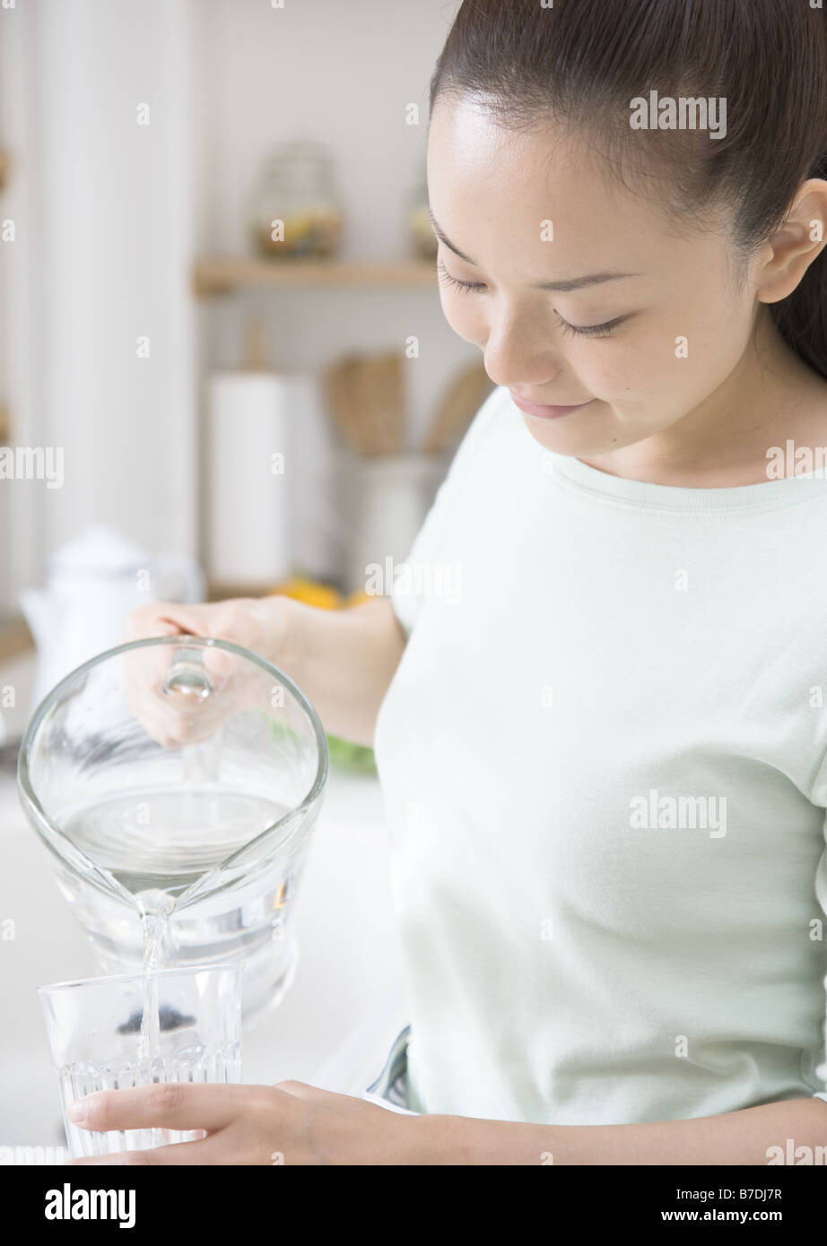 A woman pouring water Stock Photo - Alamy