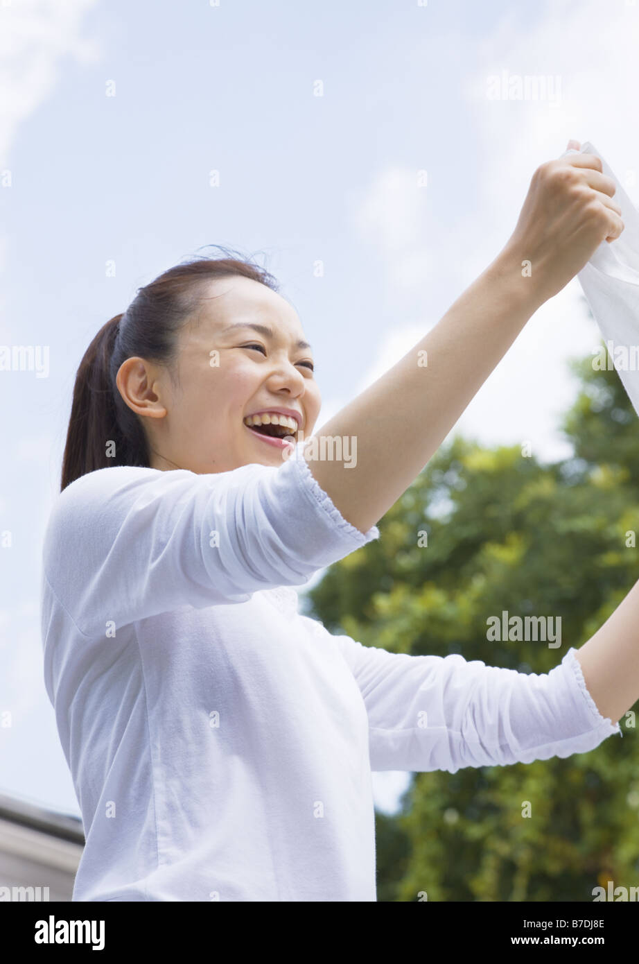 A woman spreading out laundry Stock Photo - Alamy