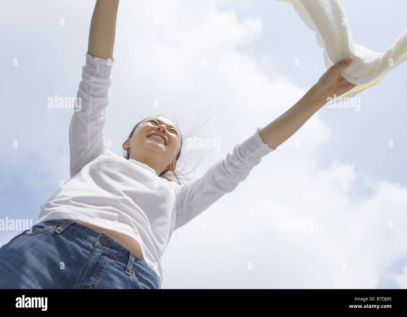 A woman spreading out laundry Stock Photo - Alamy