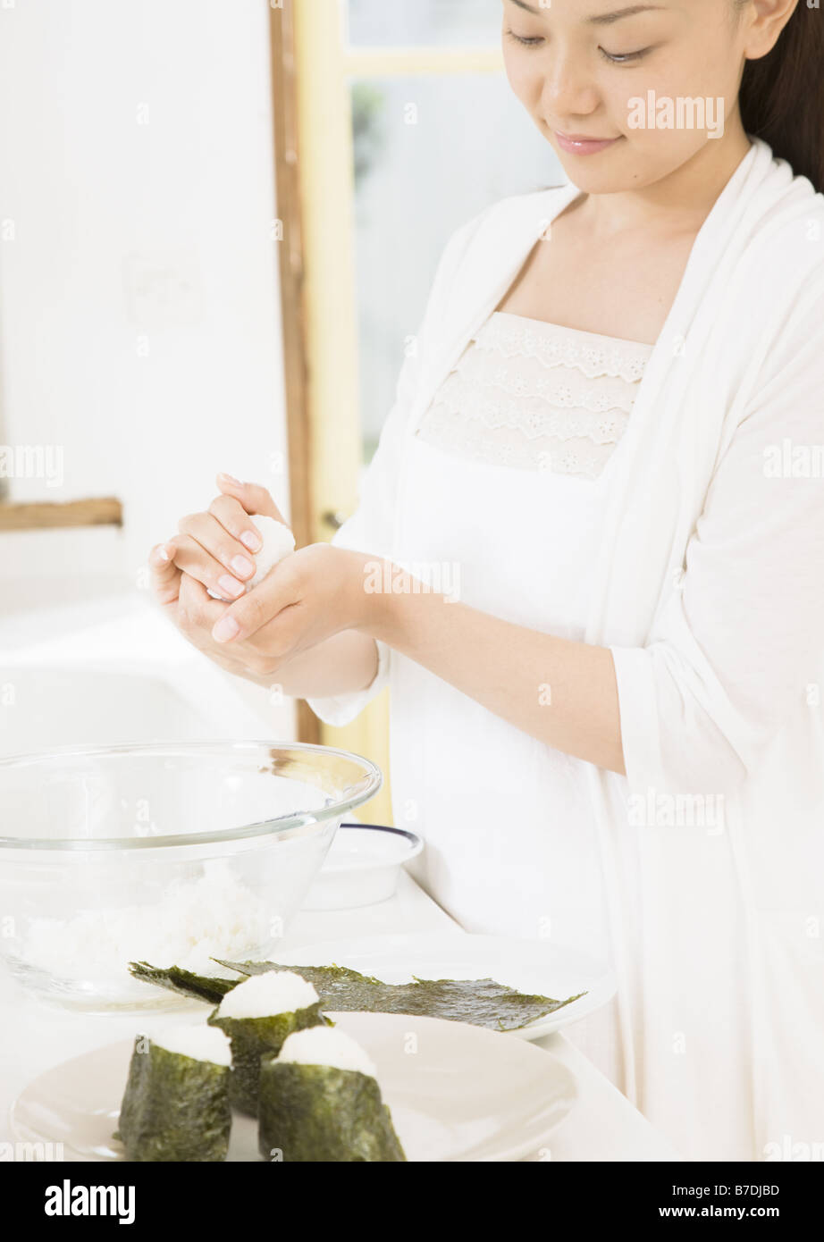 A woman making rice balls Stock Photo - Alamy