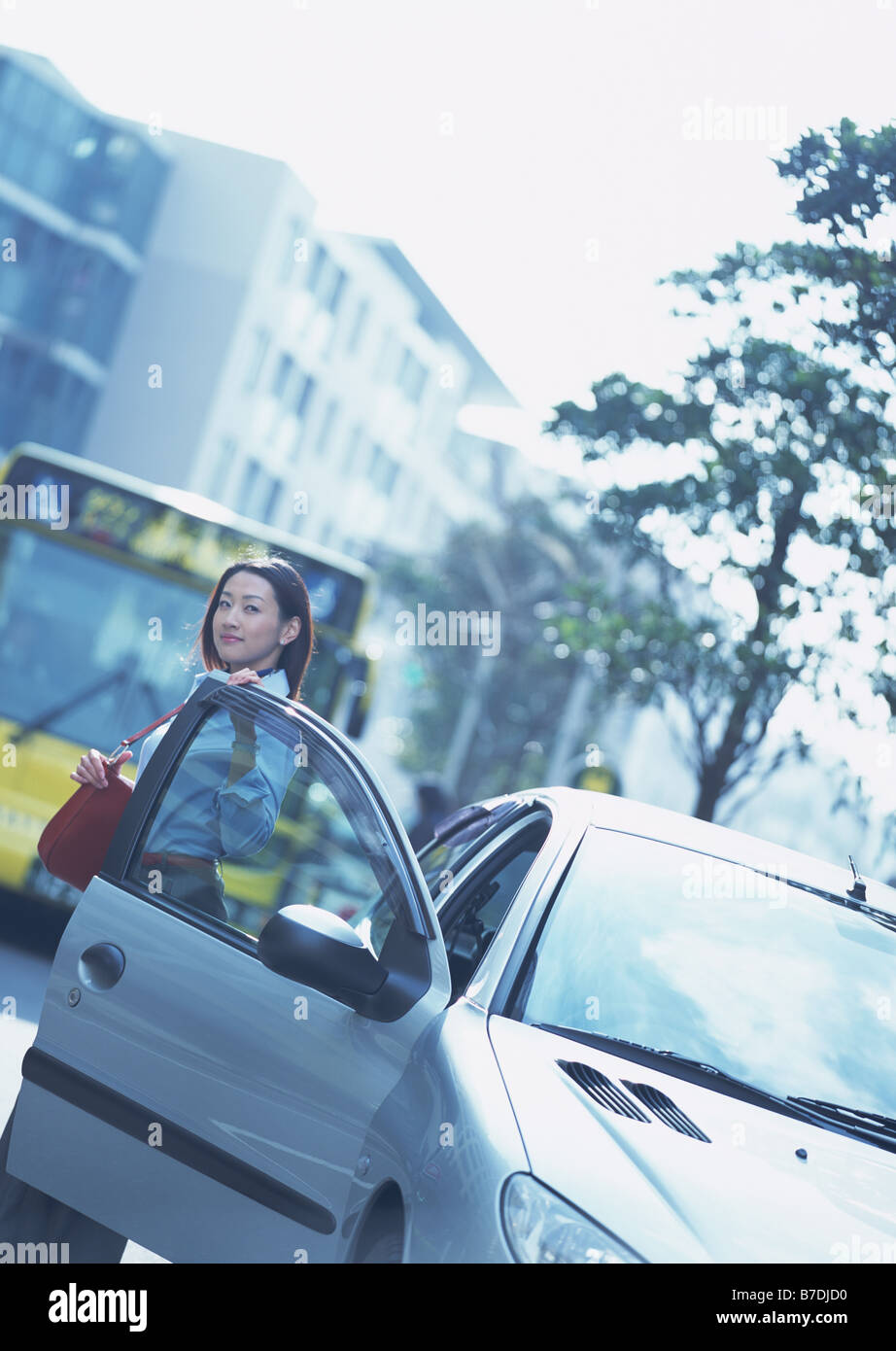 Business woman getting off a car Stock Photo - Alamy