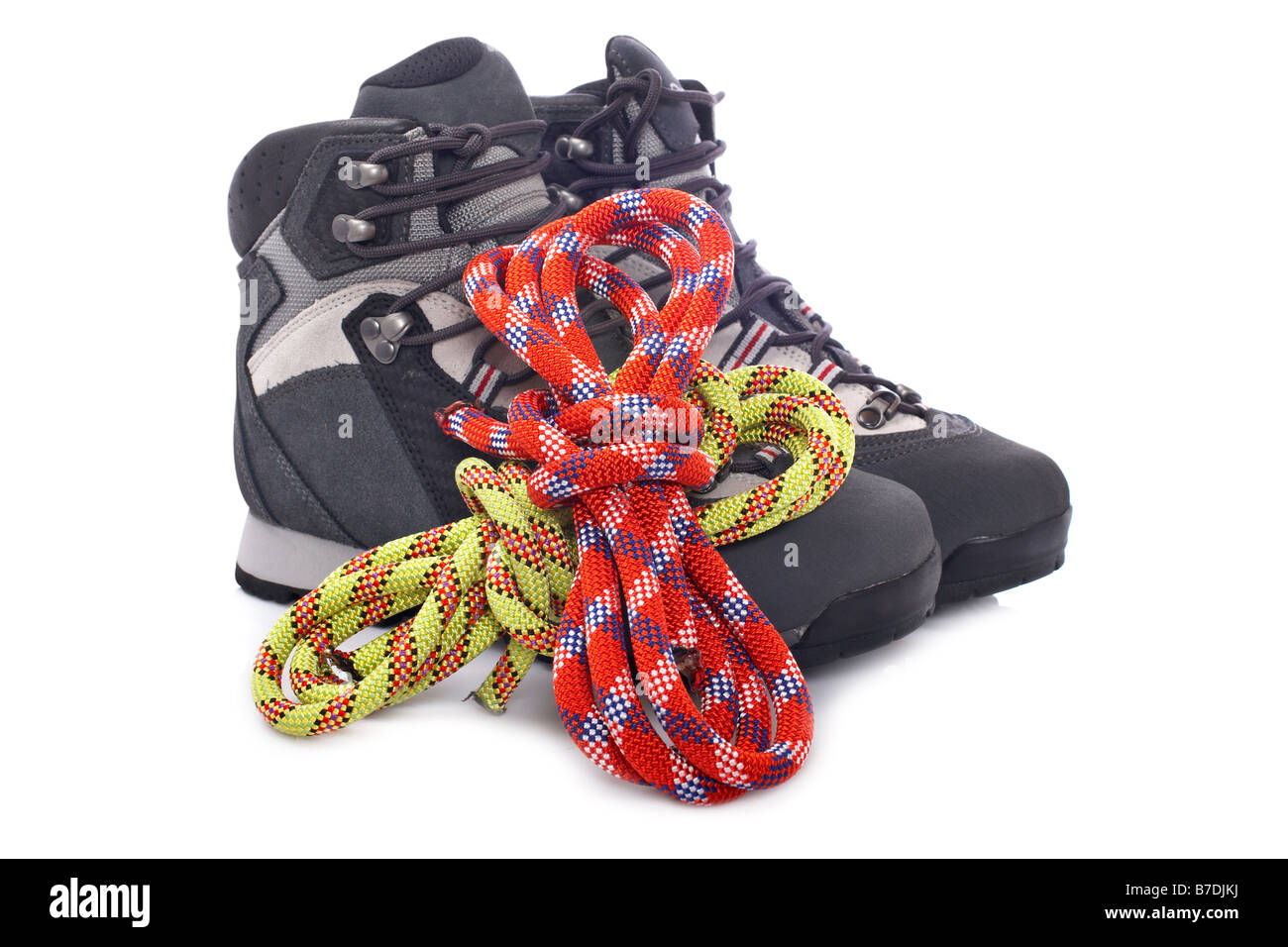 Hiking boots and two rope reflected on white background Stock Photo - Alamy