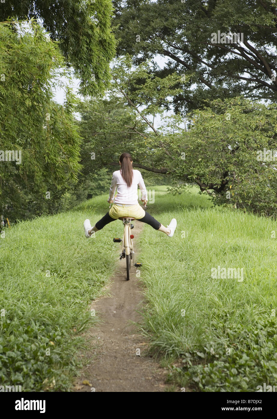 A woman riding a bicycle Stock Photo - Alamy