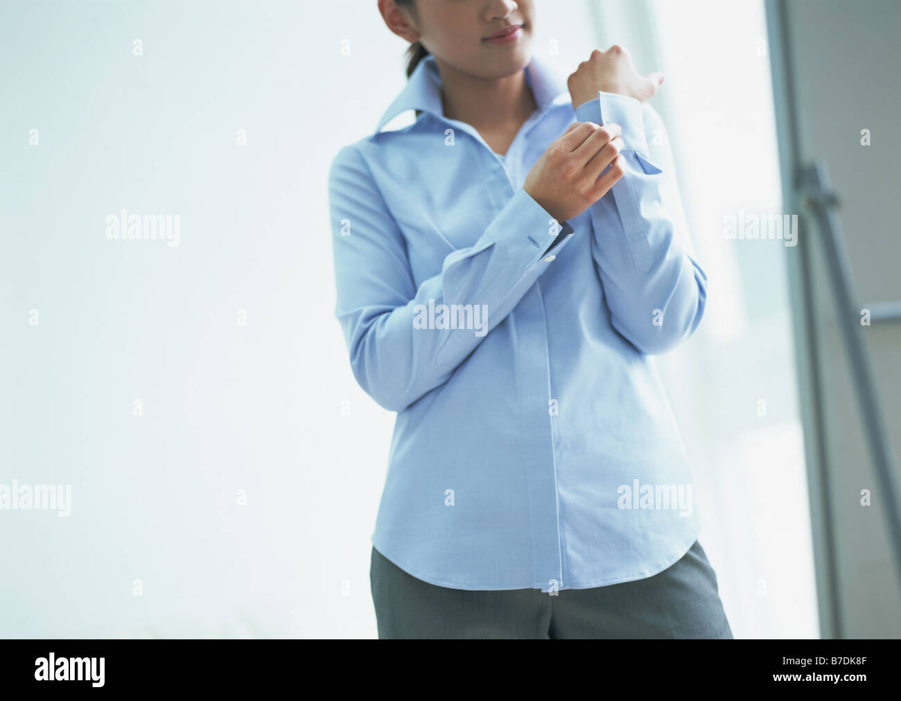 Woman getting dressed Stock Photo - Alamy