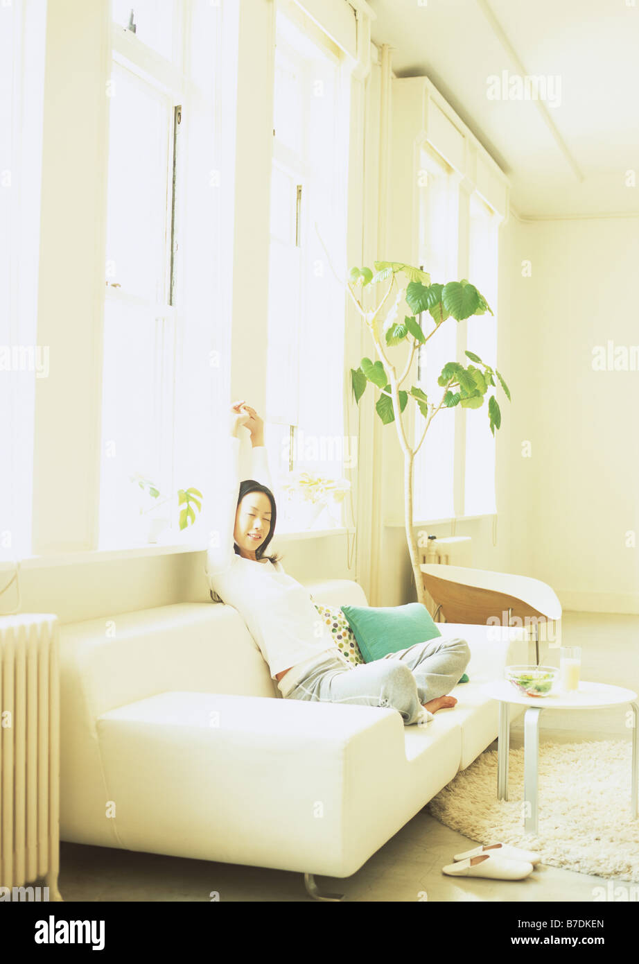 Woman relaxed on sofa Stock Photo - Alamy