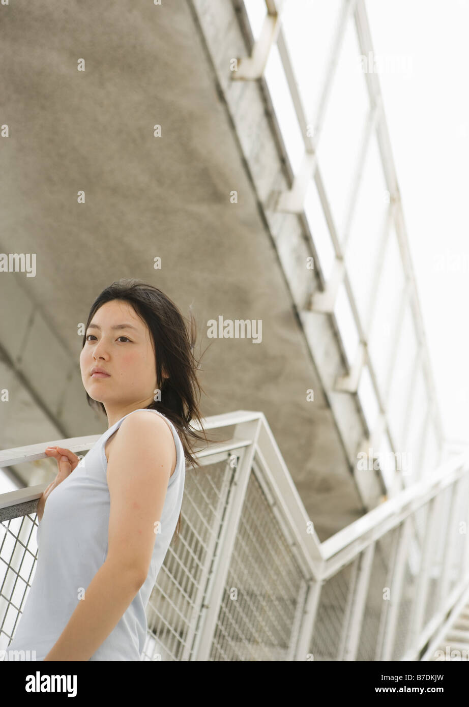 Woman standing on stairs Stock Photo - Alamy