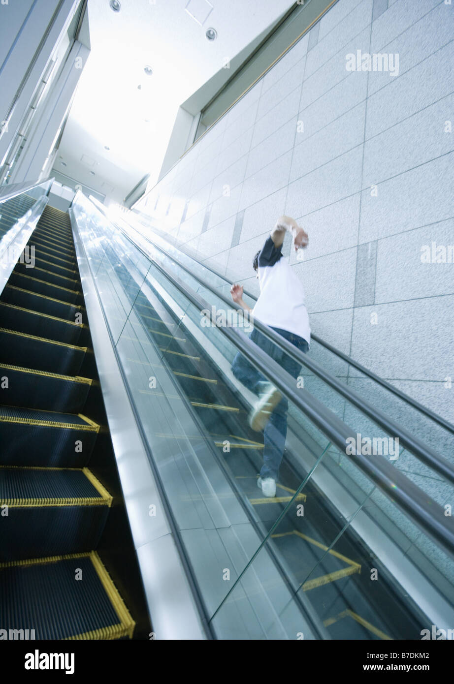 Young man running up escalator Stock Photo - Alamy Young man running up escalator Stock Photo - Alamy