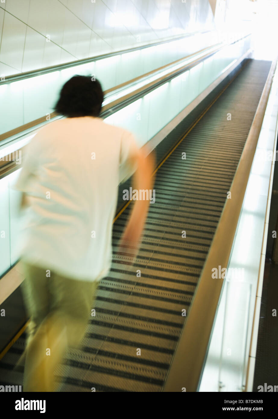 Man running on moving sidewalk Stock Photo - Alamy