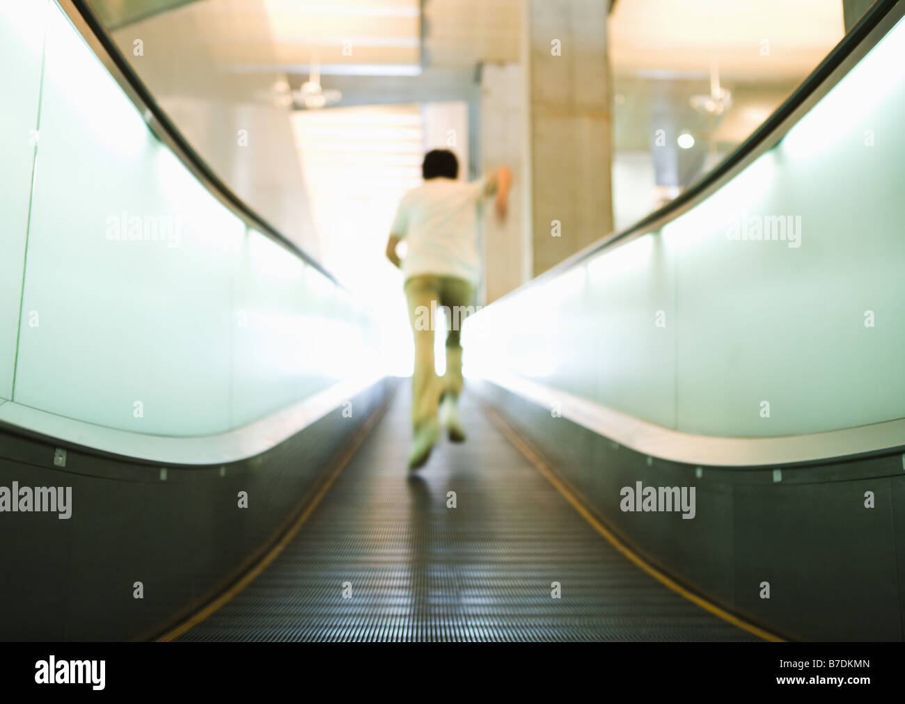 Man running on moving sidewalk Stock Photo - Alamy