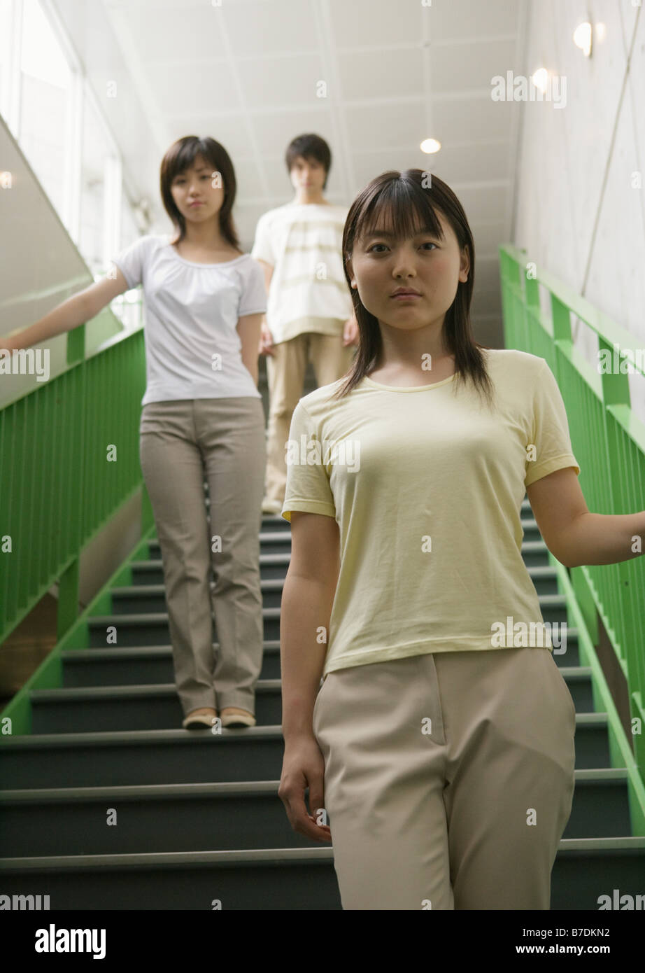 Young people standing on stairs Stock Photo - Alamy
