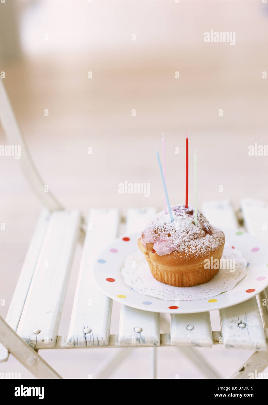 Birthday cup cake on chair Stock Photo - Alamy