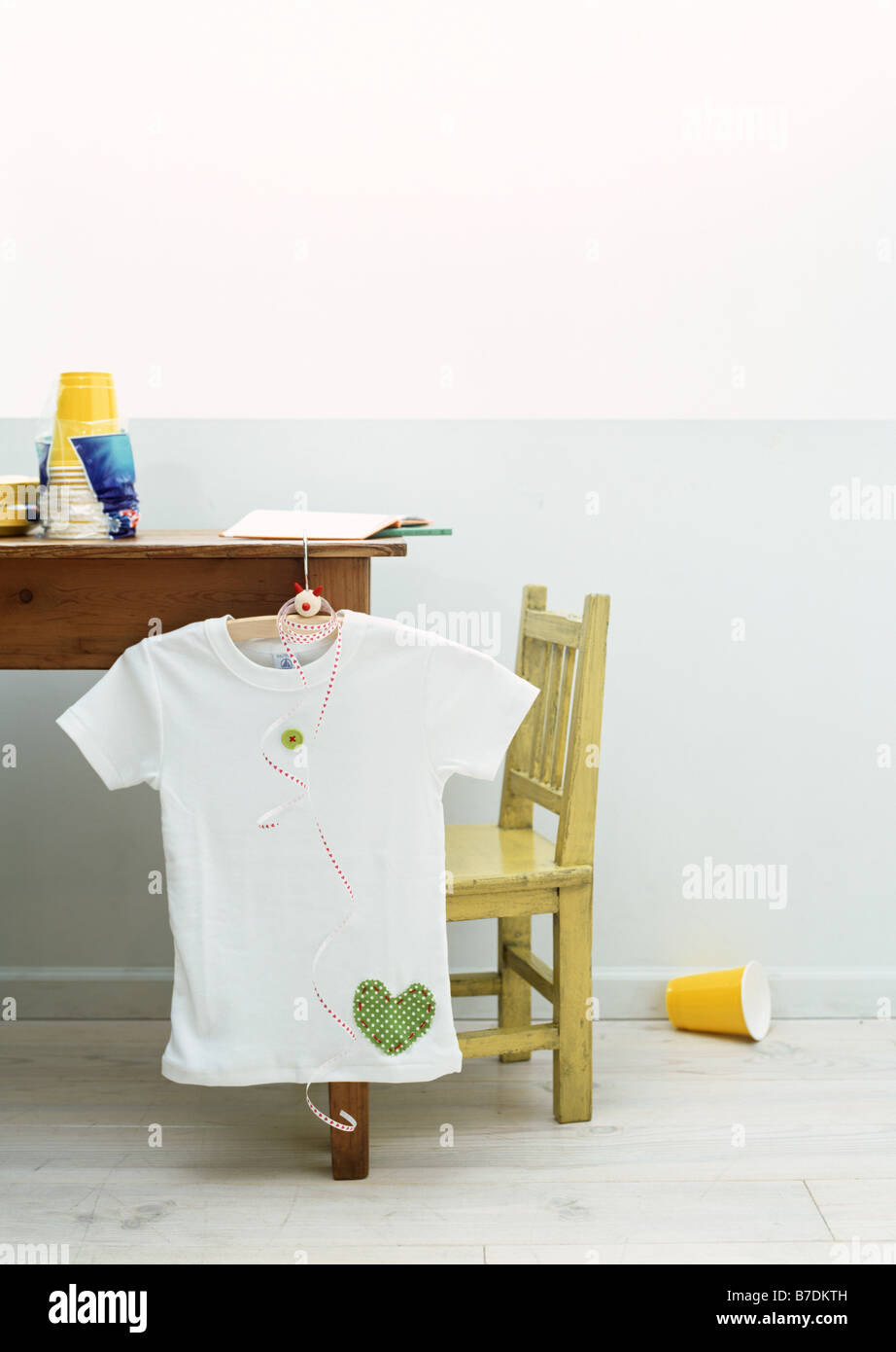 Appliqued t-shirt hanging on desk Stock Photo - Alamy