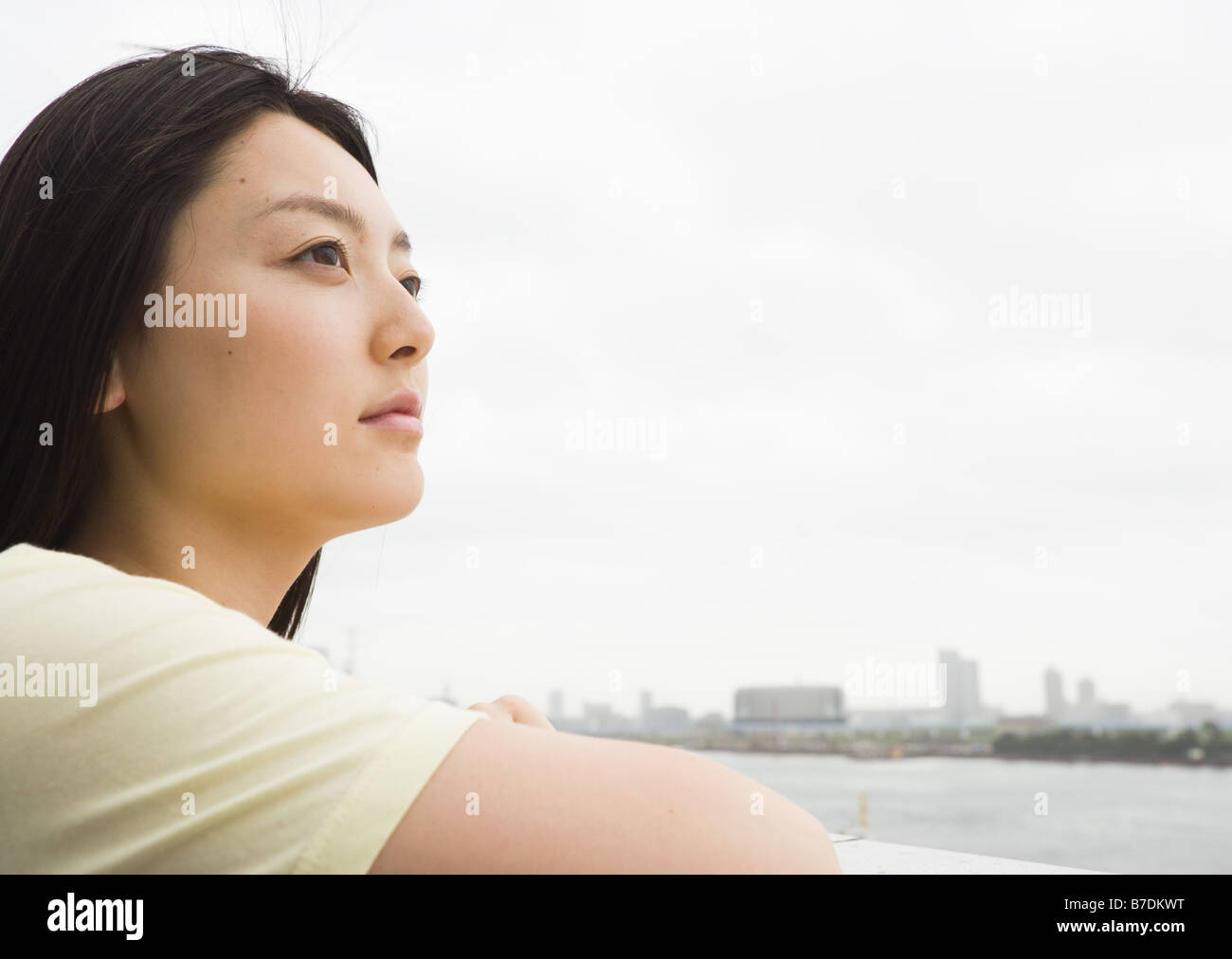 Side view of young woman looking away Stock Photo - Alamy