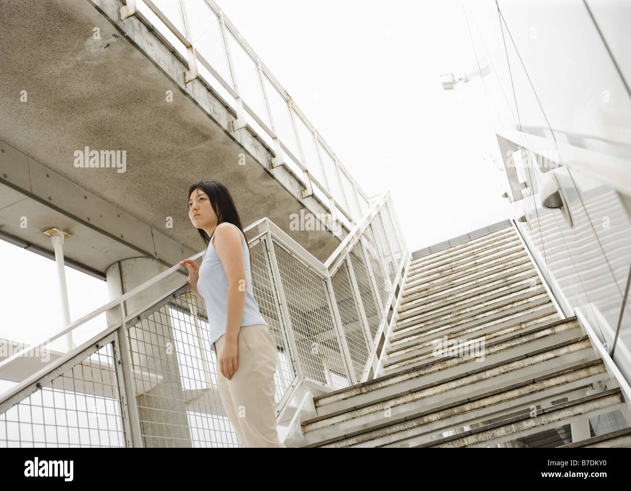 Woman standing on stairs Stock Photo - Alamy
