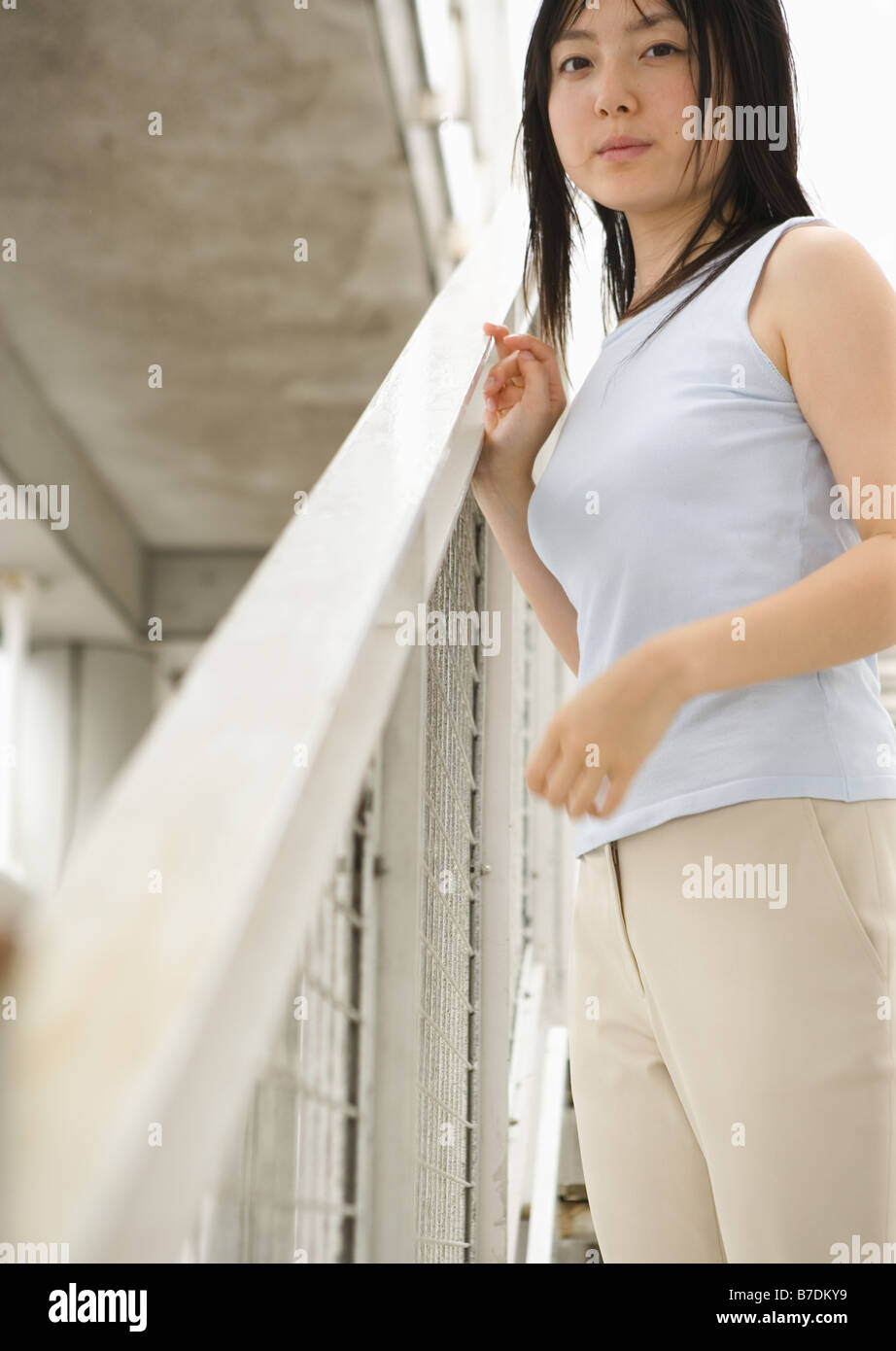 Woman standing on stairs Stock Photo - Alamy
