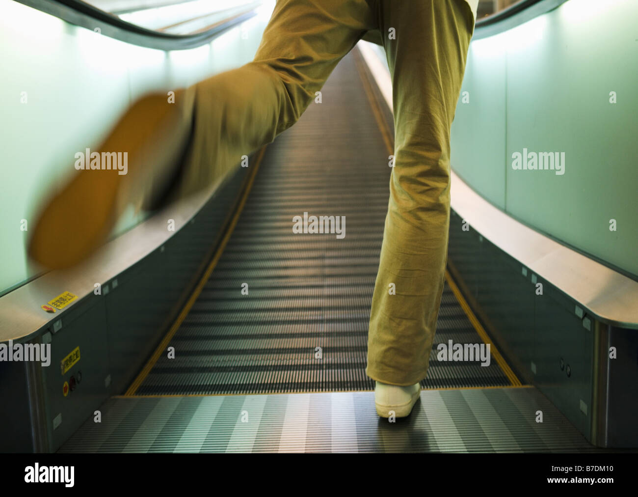 Man running on moving sidewalk Stock Photo - Alamy