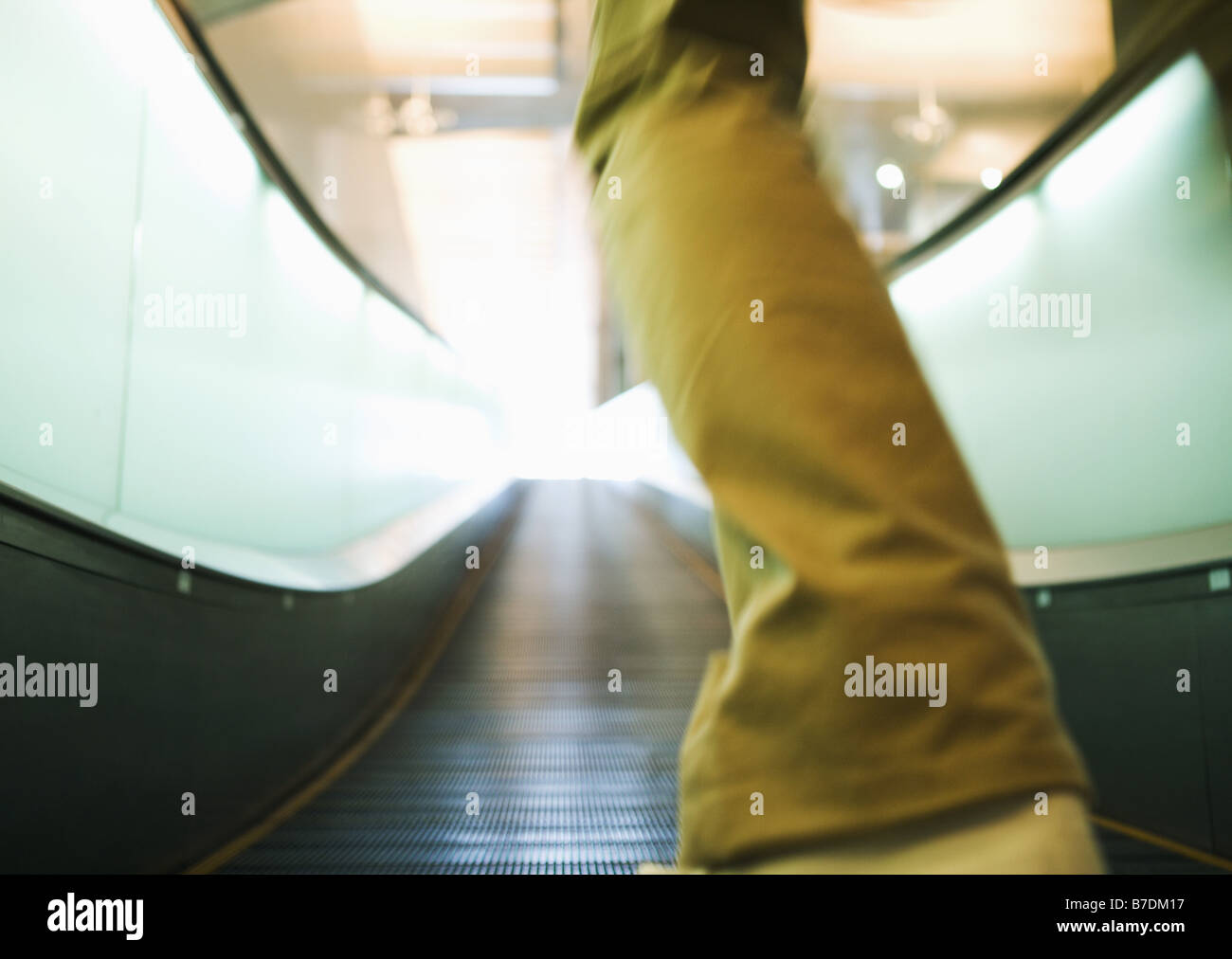 Man running on moving sidewalk Stock Photo - Alamy