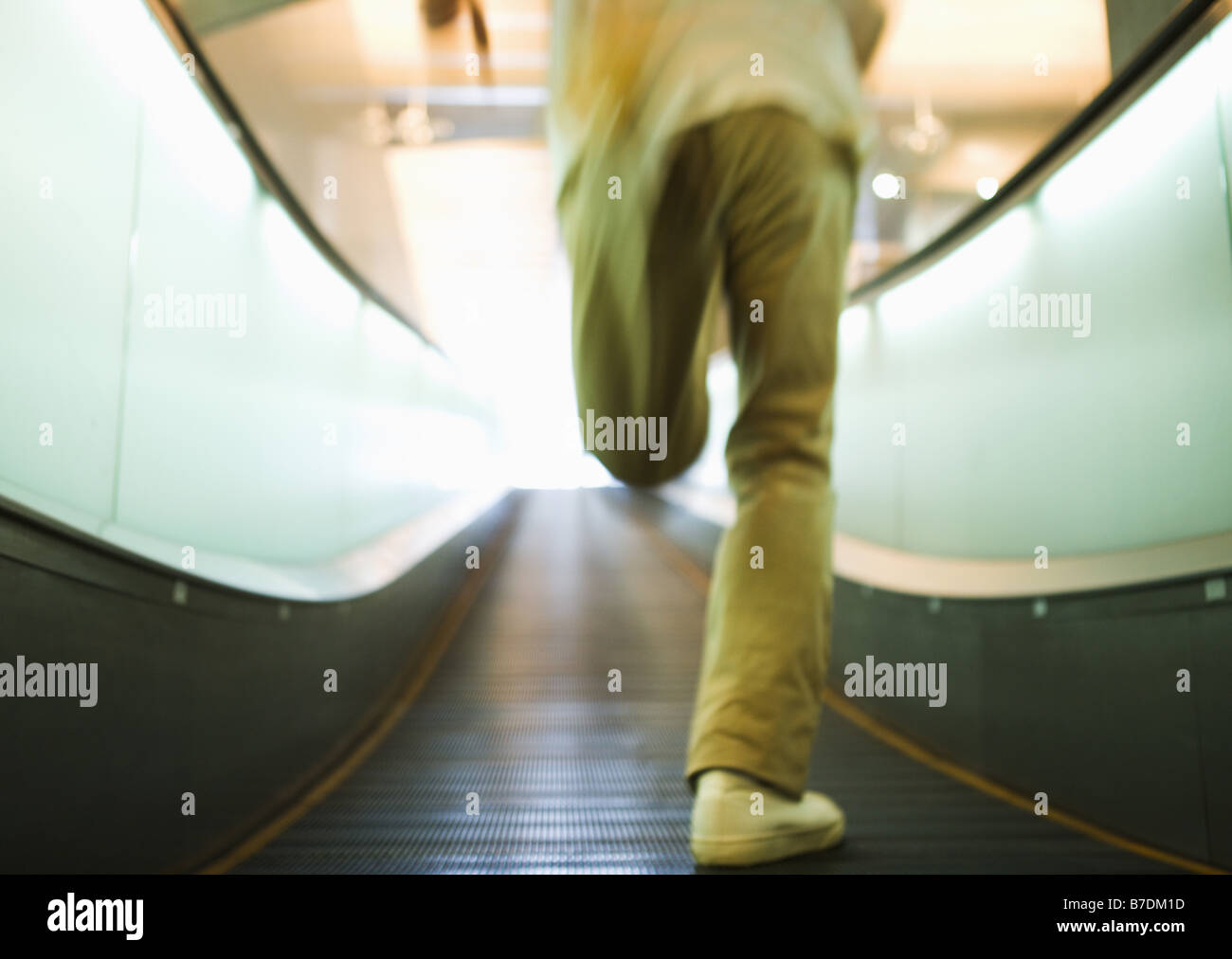 Man running on moving sidewalk Stock Photo - Alamy