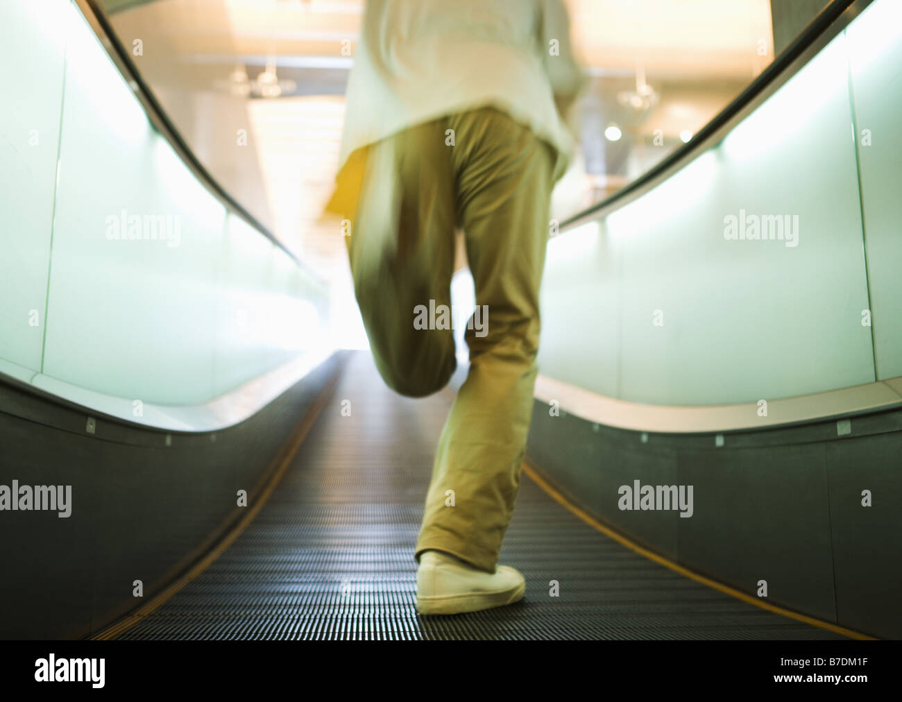 Man running on moving sidewalk Stock Photo - Alamy