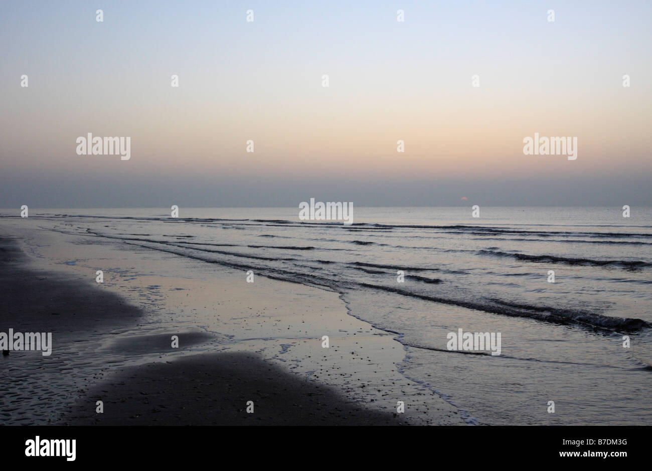 Sand, frost, and ice on a beach on Romo, an island in the North sea ...