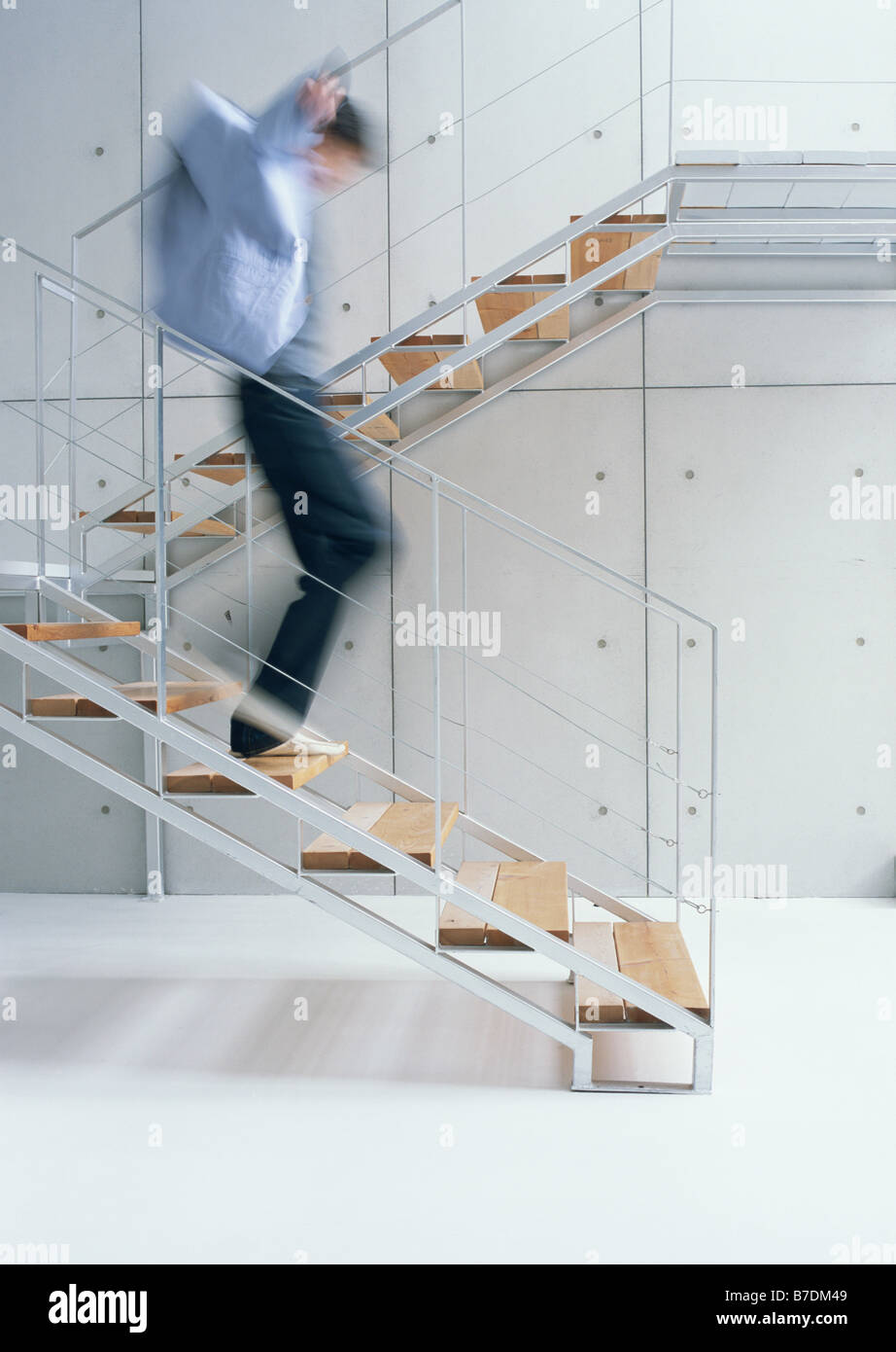 Man going down stairs Stock Photo - Alamy
