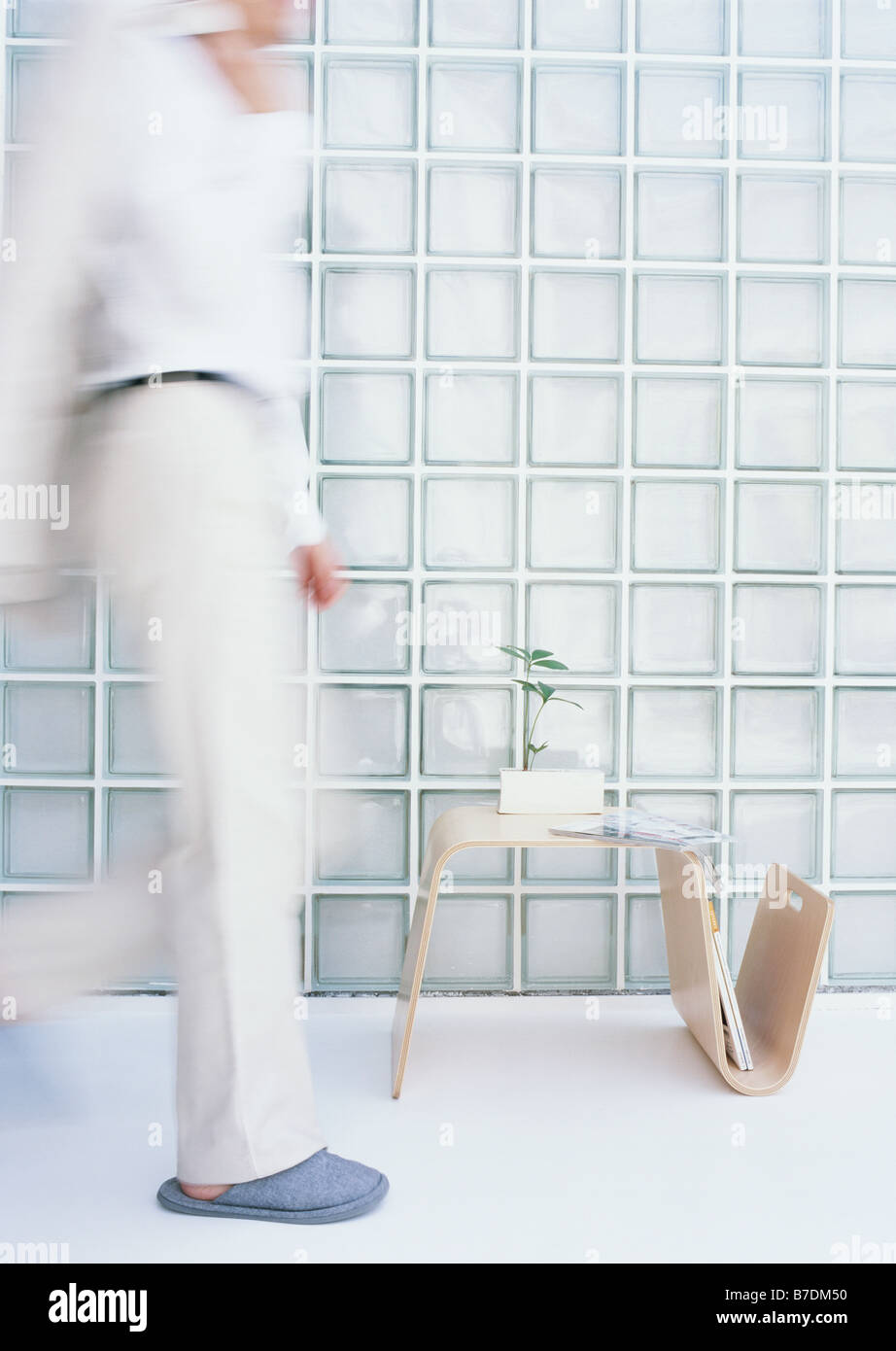 Man walking in room Stock Photo - Alamy