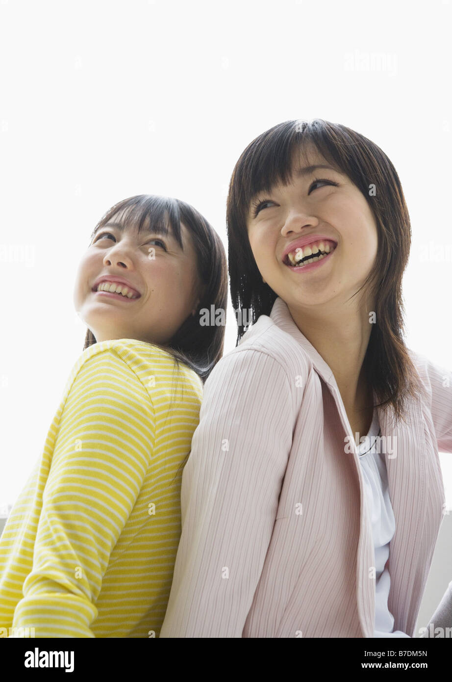 Two girls lean back back hi-res stock photography and images - Alamy