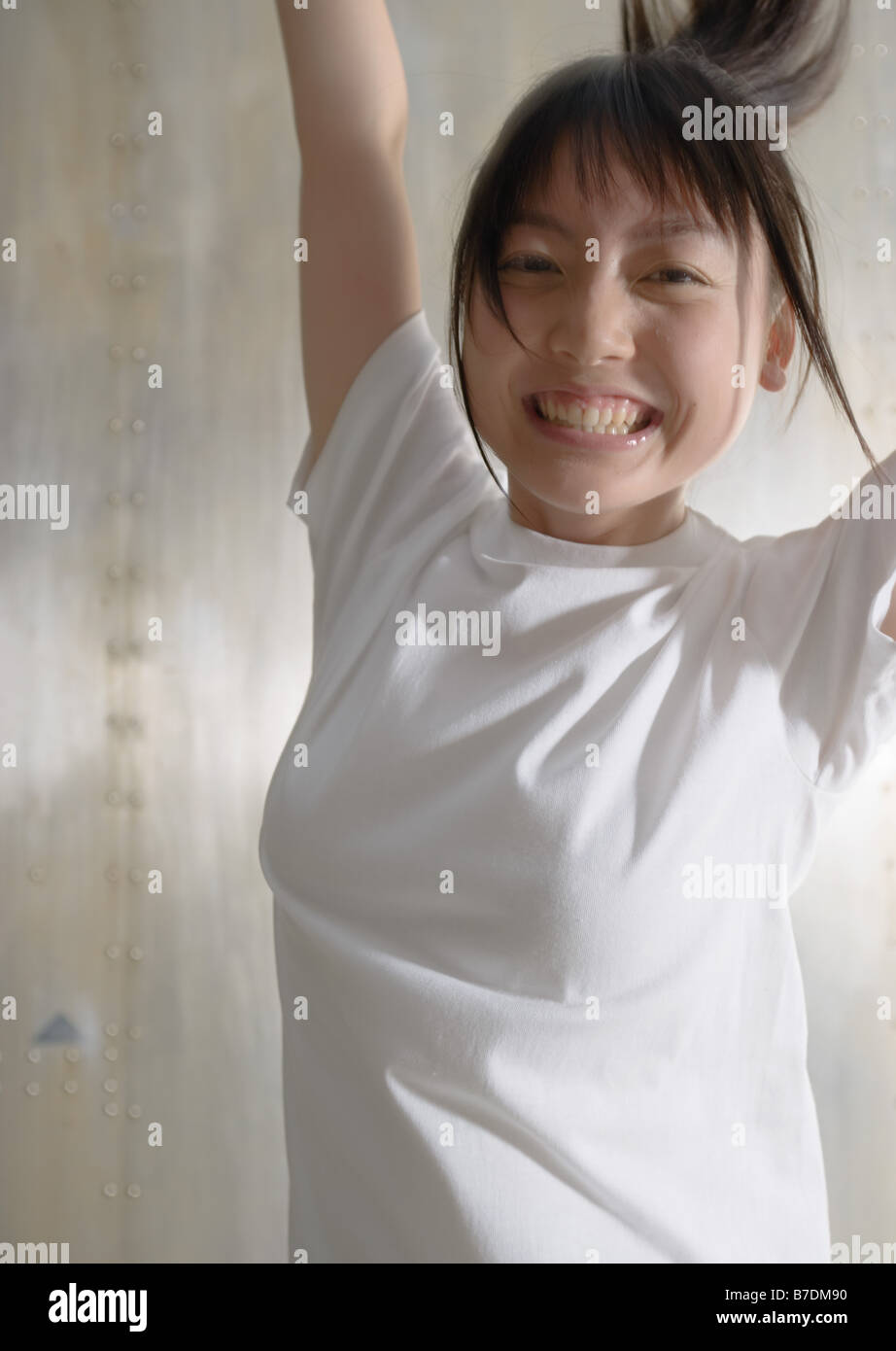 Smiling girls with arms raised Stock Photo - Alamy