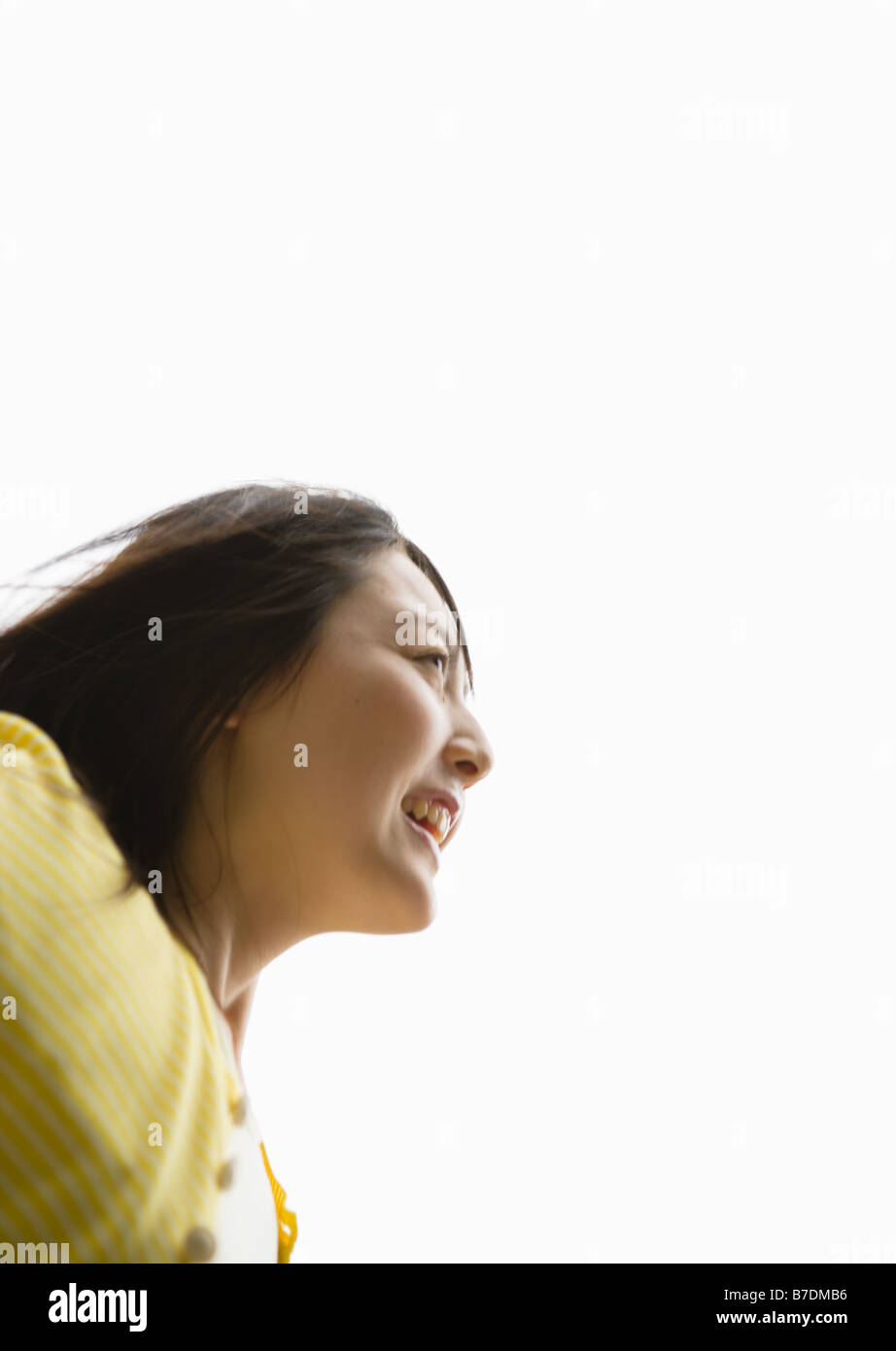 Side view of smiling young girl Stock Photo - Alamy