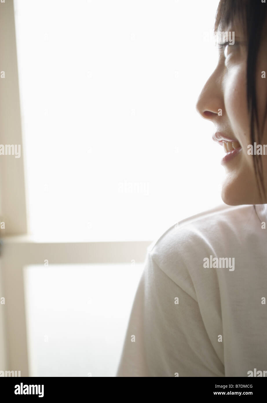 Girl by window in school uniform Stock Photo - Alamy