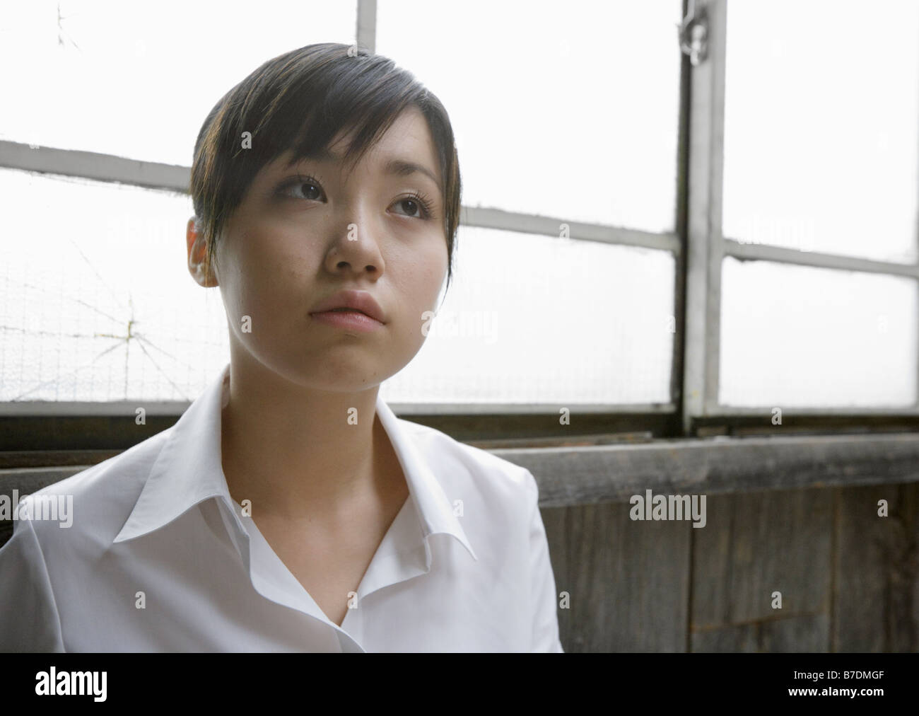 Girl by window in school uniform Stock Photo - Alamy