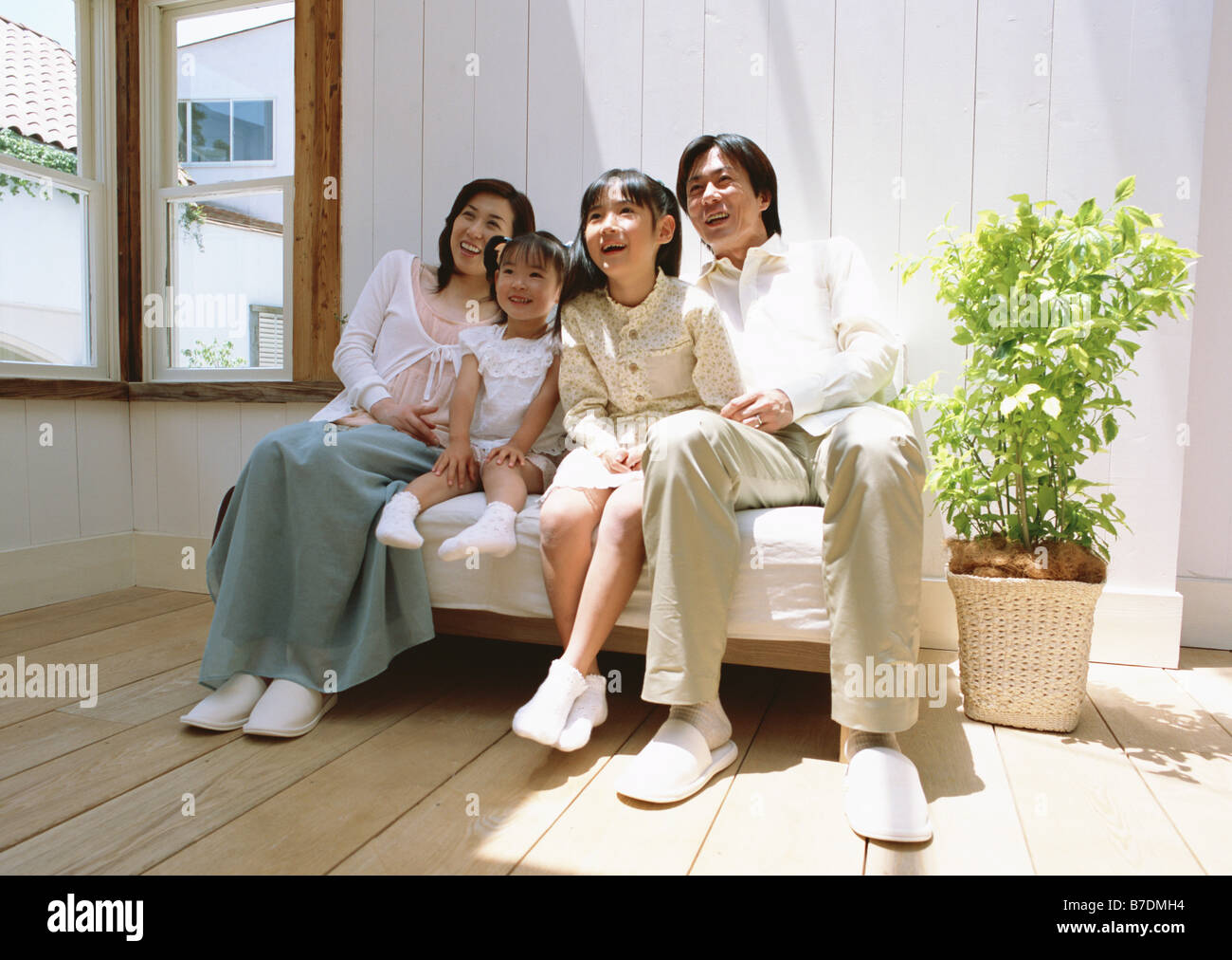 Family relaxed on the sofa Stock Photo - Alamy